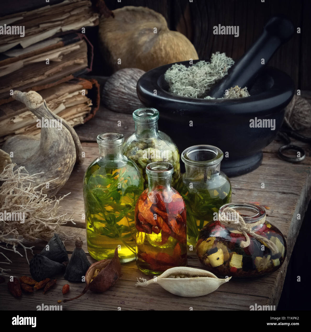 Bottles of essential oil or potion, mortar of dried moss, old books ...