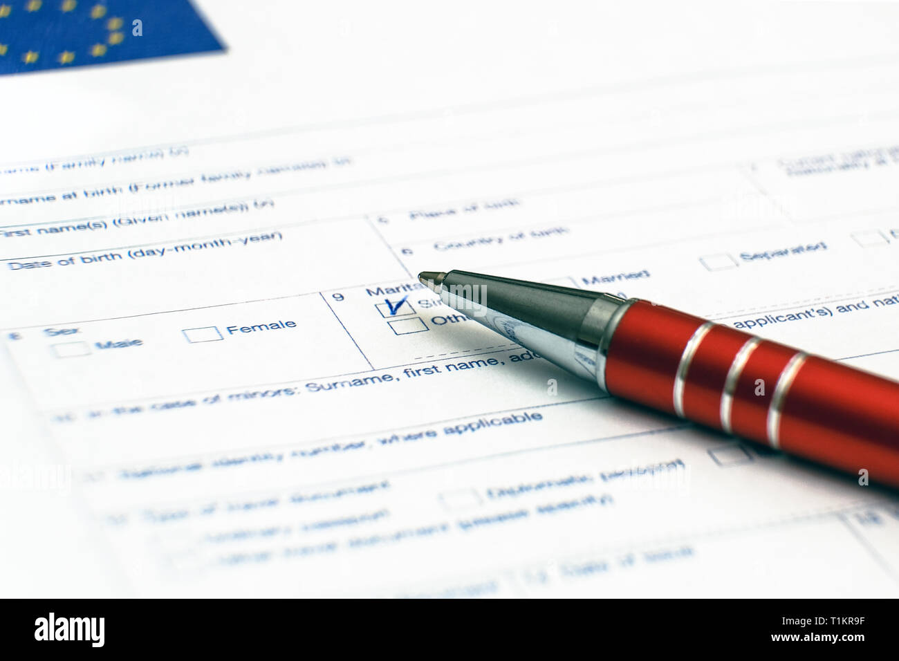 Schengen visa, questionnaire. Hand with pen completing a questionary ...