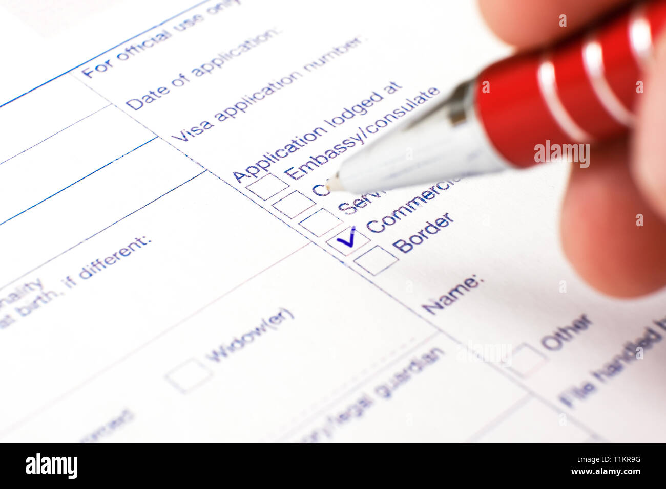 Schengen visa, questionnaire. Hand with pen completing a questionary ...