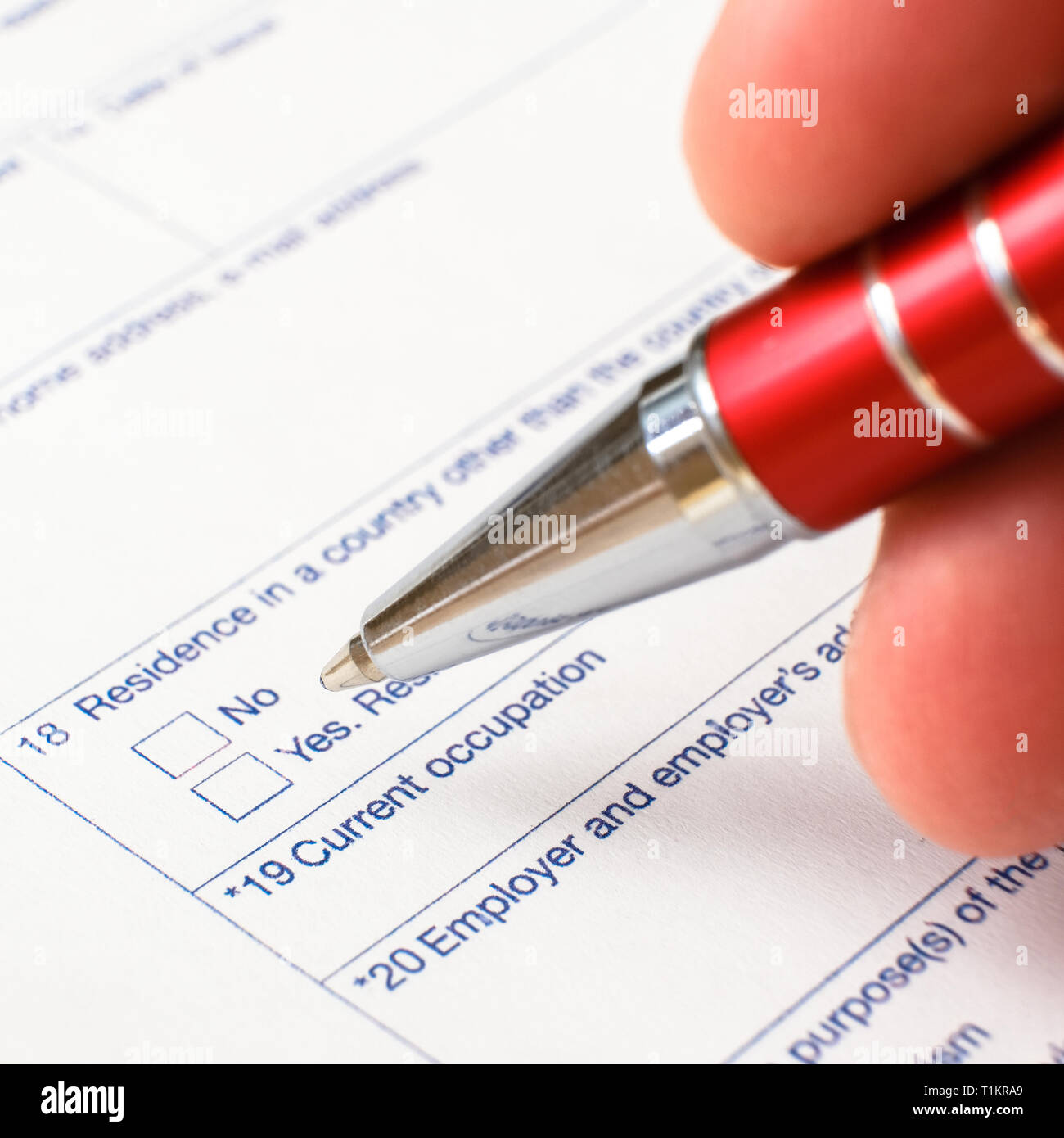 Schengen visa, questionnaire. Hand with pen completing a questionary ...