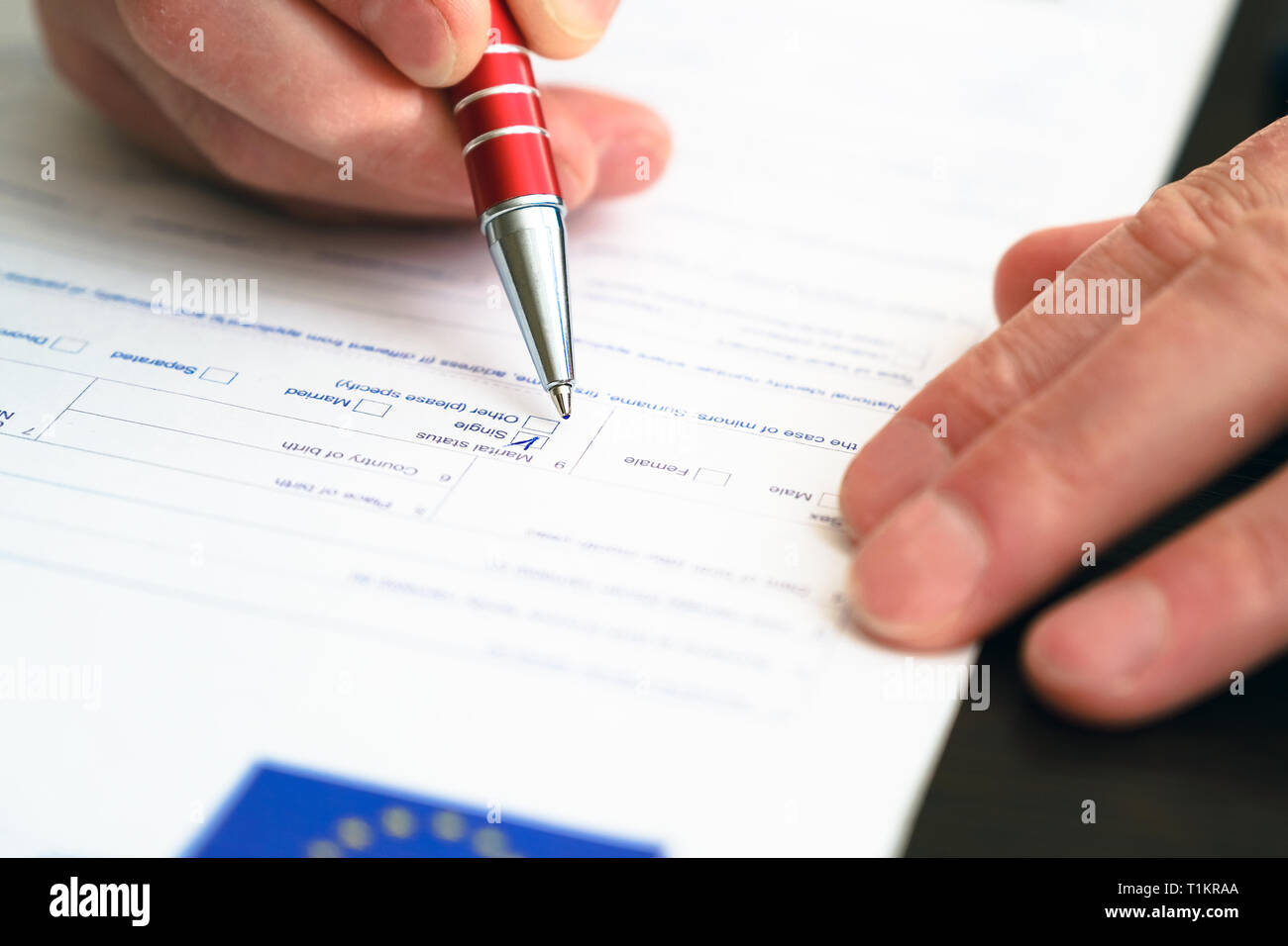 Schengen visa, questionnaire. Hand with pen completing a questionary ...