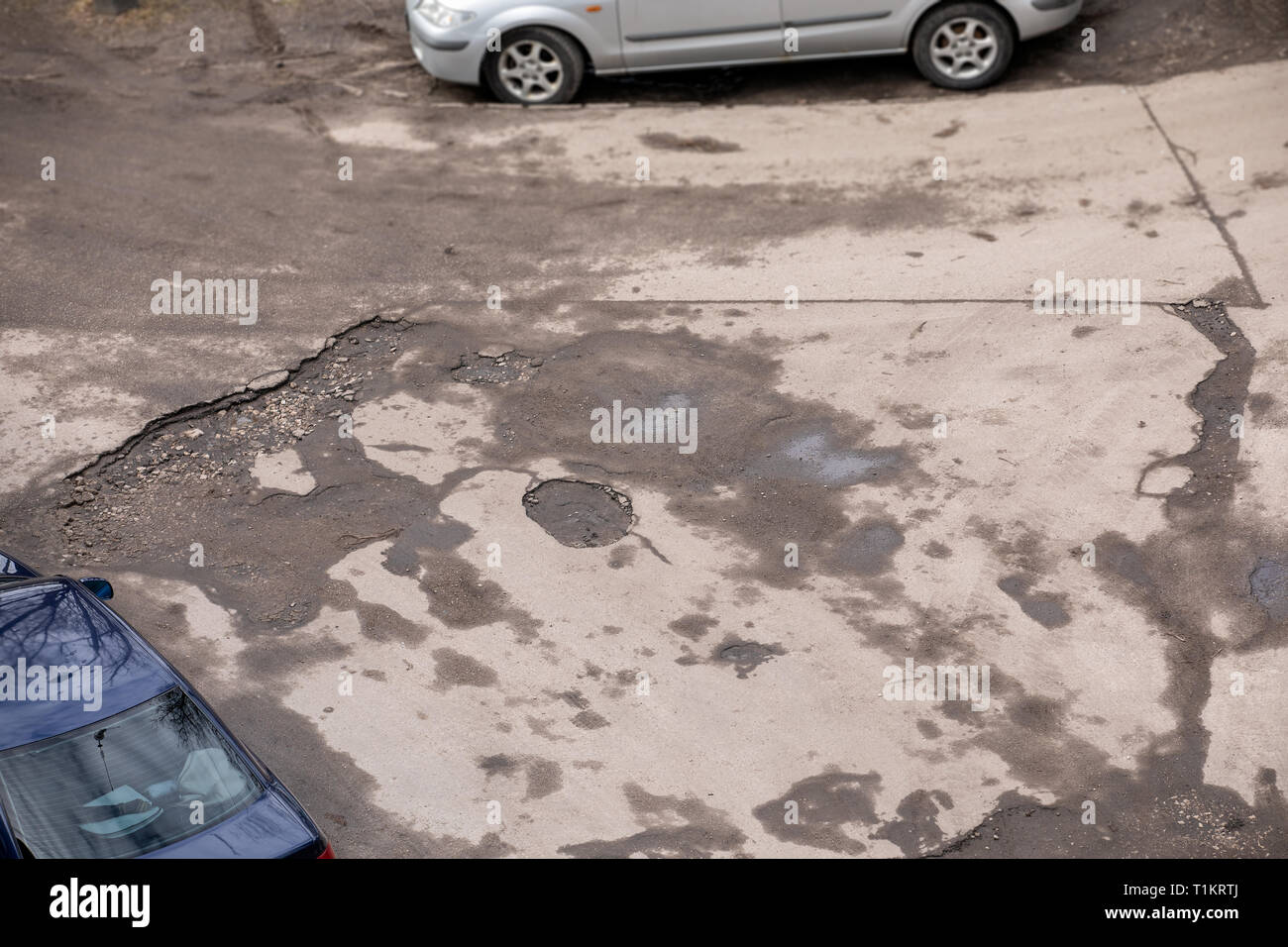 Damaged asphalt road with potholes Stock Photo - Alamy