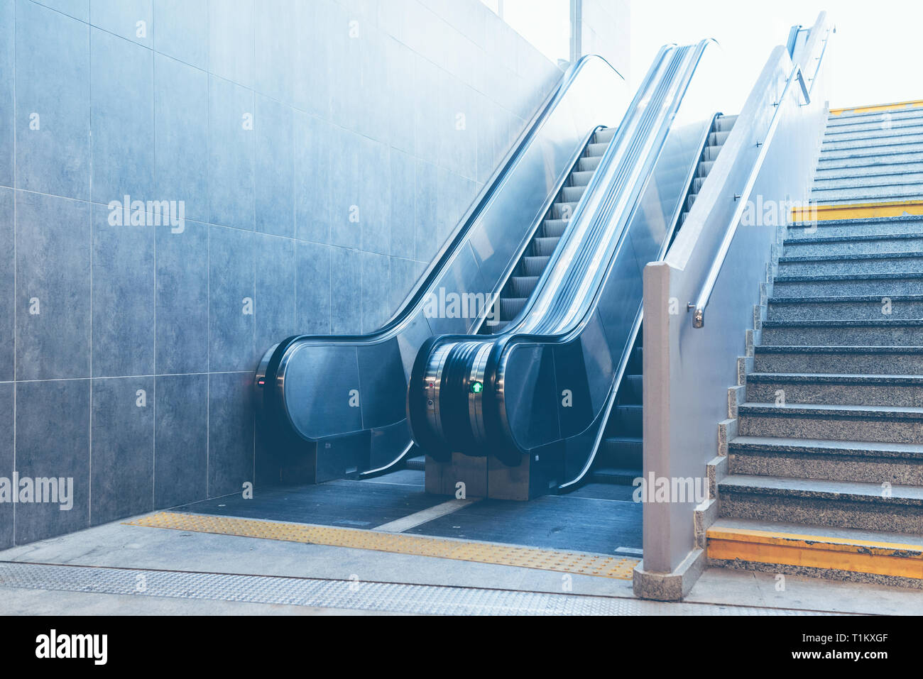 Full frame take of a stone staircase next to a modern escalator Stock ...