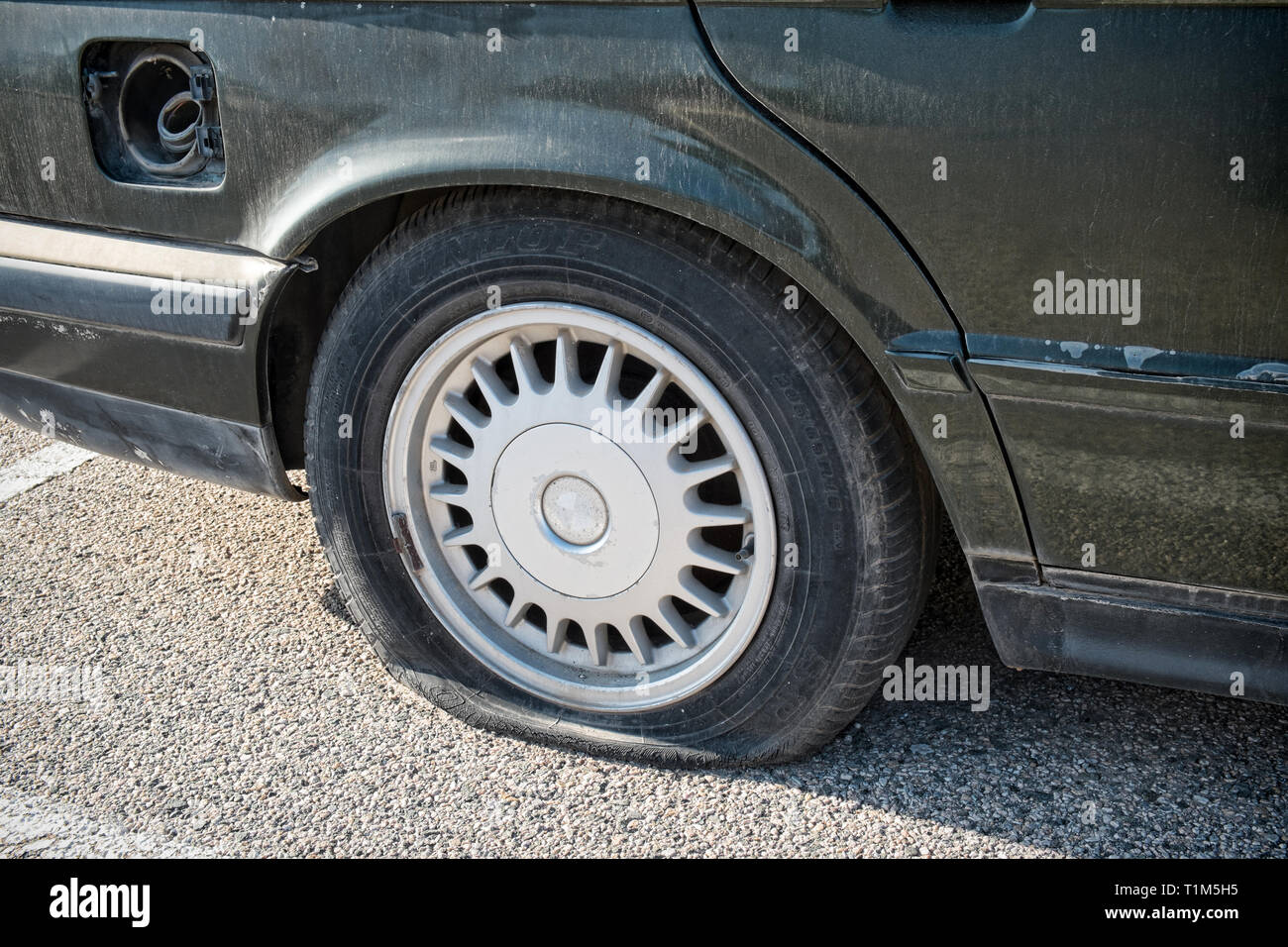 Wasted care with punctured tyres and and open fuel tank Stock Photo - Alamy