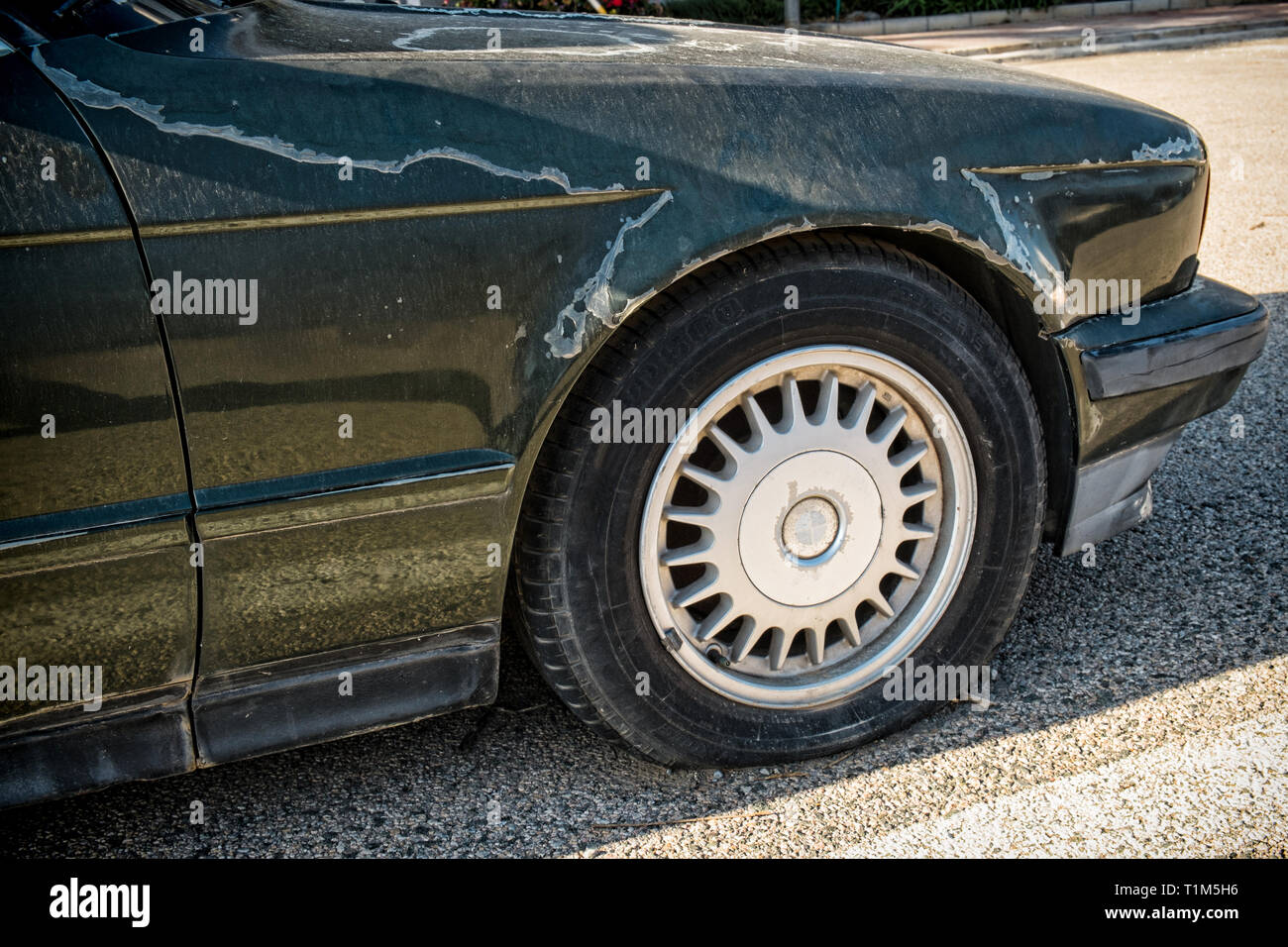 Wasted care with punctured tyres and and open fuel tank Stock Photo - Alamy