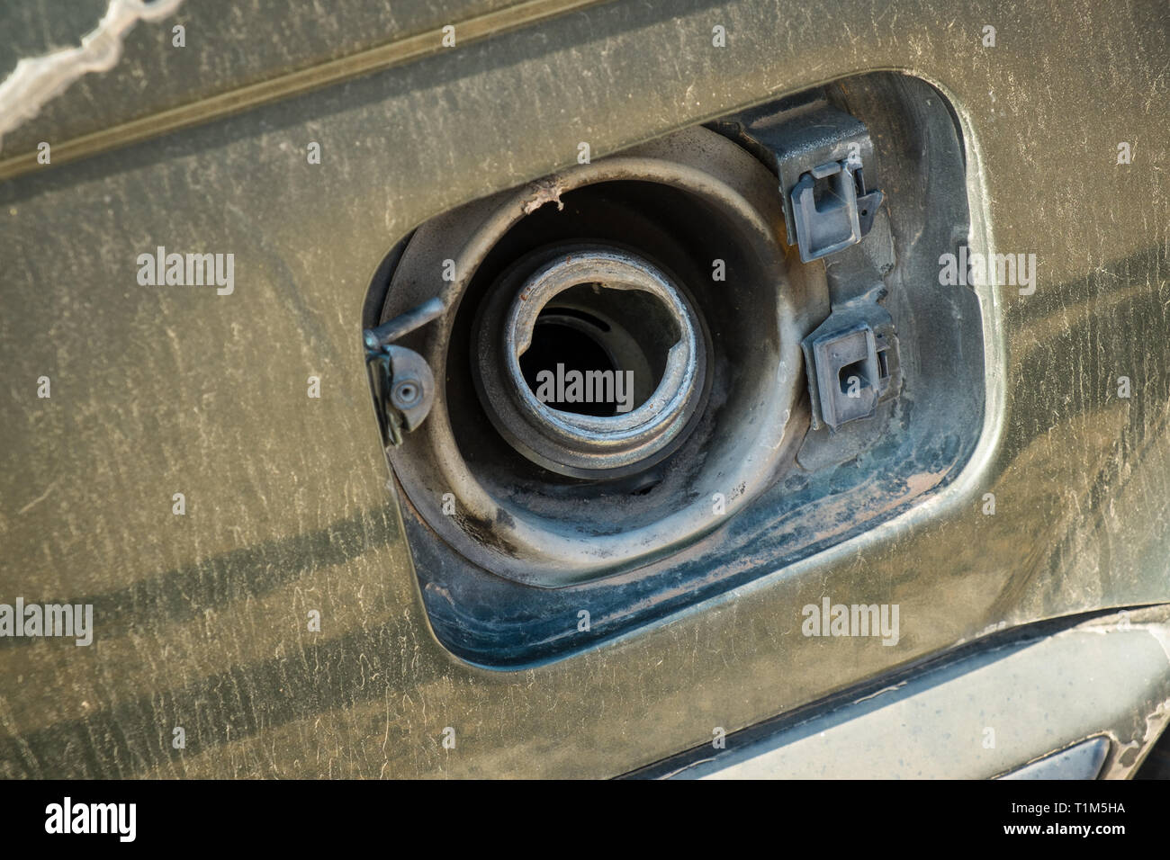 Broken tank opening on a scrap car Stock Photo - Alamy
