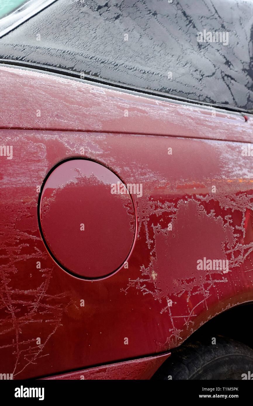 ice crystals from a hard frost on a car fuel filler cap concept of a ...