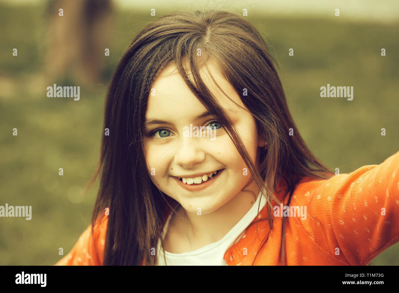 Happy smiling small girl outdoor Stock Photo - Alamy