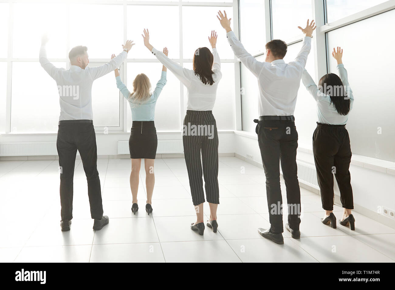 rear view.happy business team standing in bright new office Stock Photo ...