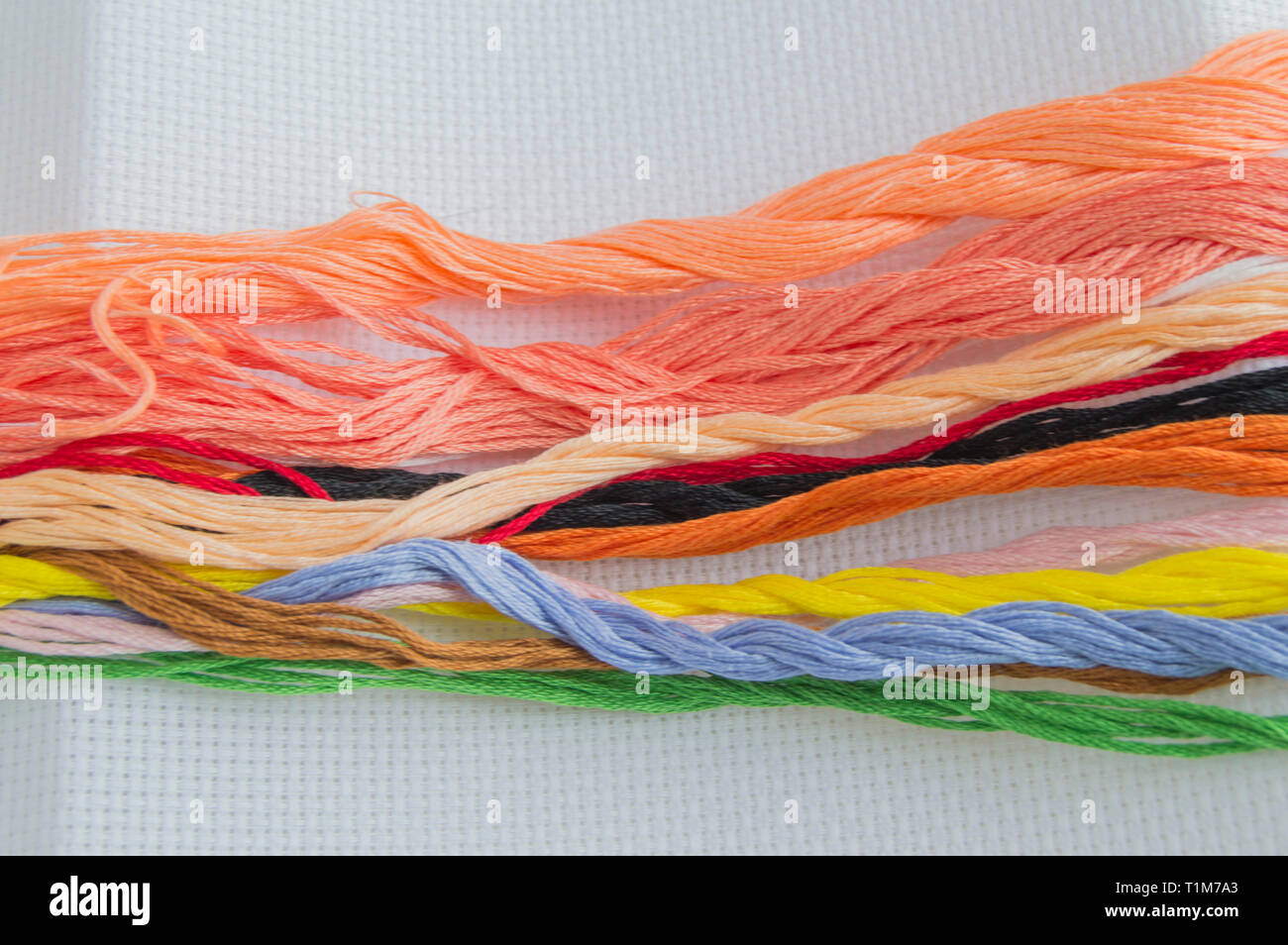 Bright colorful thread for embroidery thread on canvas. Handmade ...