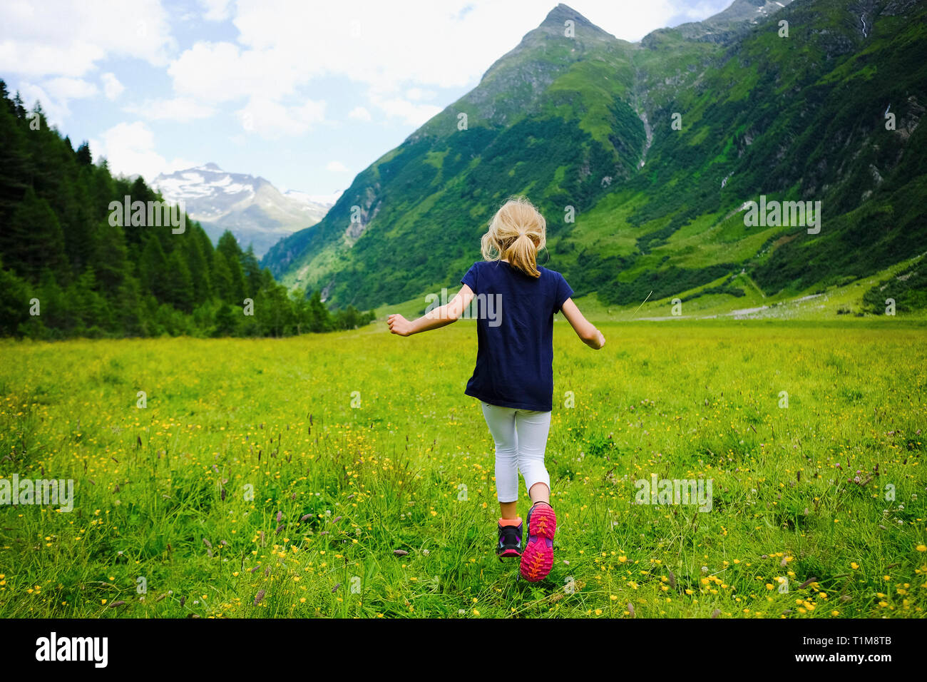 Carefree girl running in idyllic mountain valley, Innergschloess, Tyrol ...
