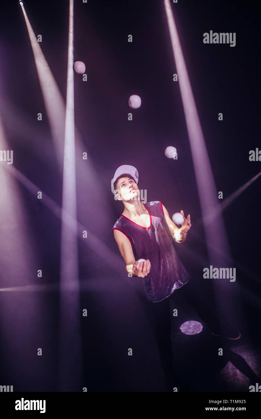 Male performer juggling balls on stage Stock Photo - Alamy