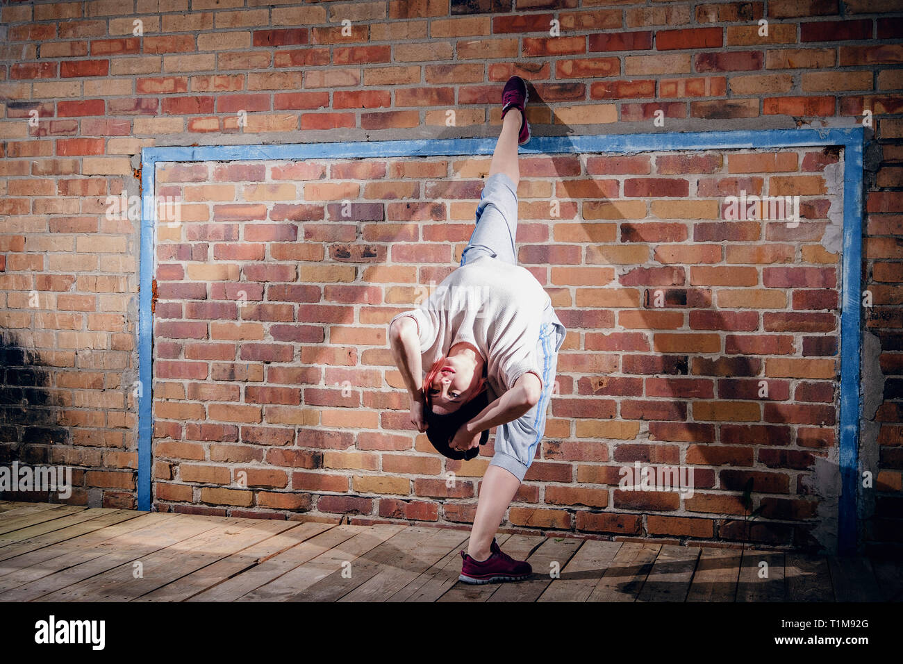 Female modern dancer performing against brick wall Stock Photo - Alamy