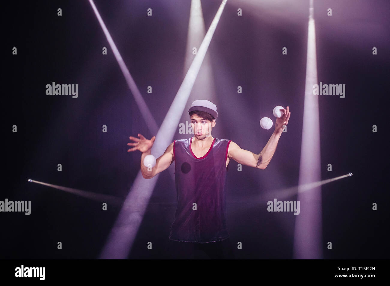 Male performer juggling on stage Stock Photo - Alamy