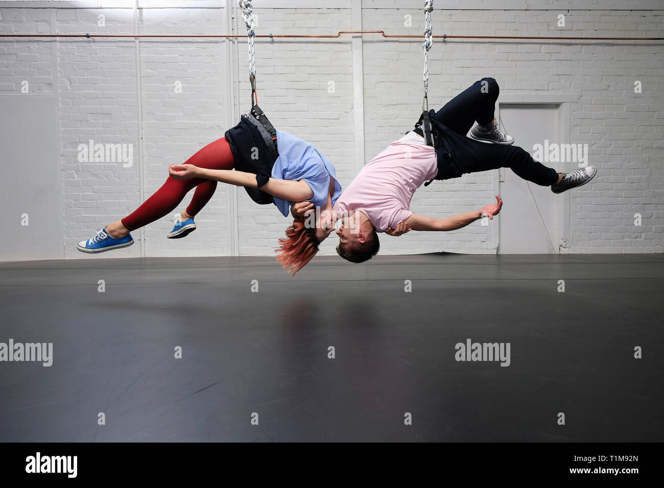 Young women hanging upside down hi-res stock photography and images - Alamy