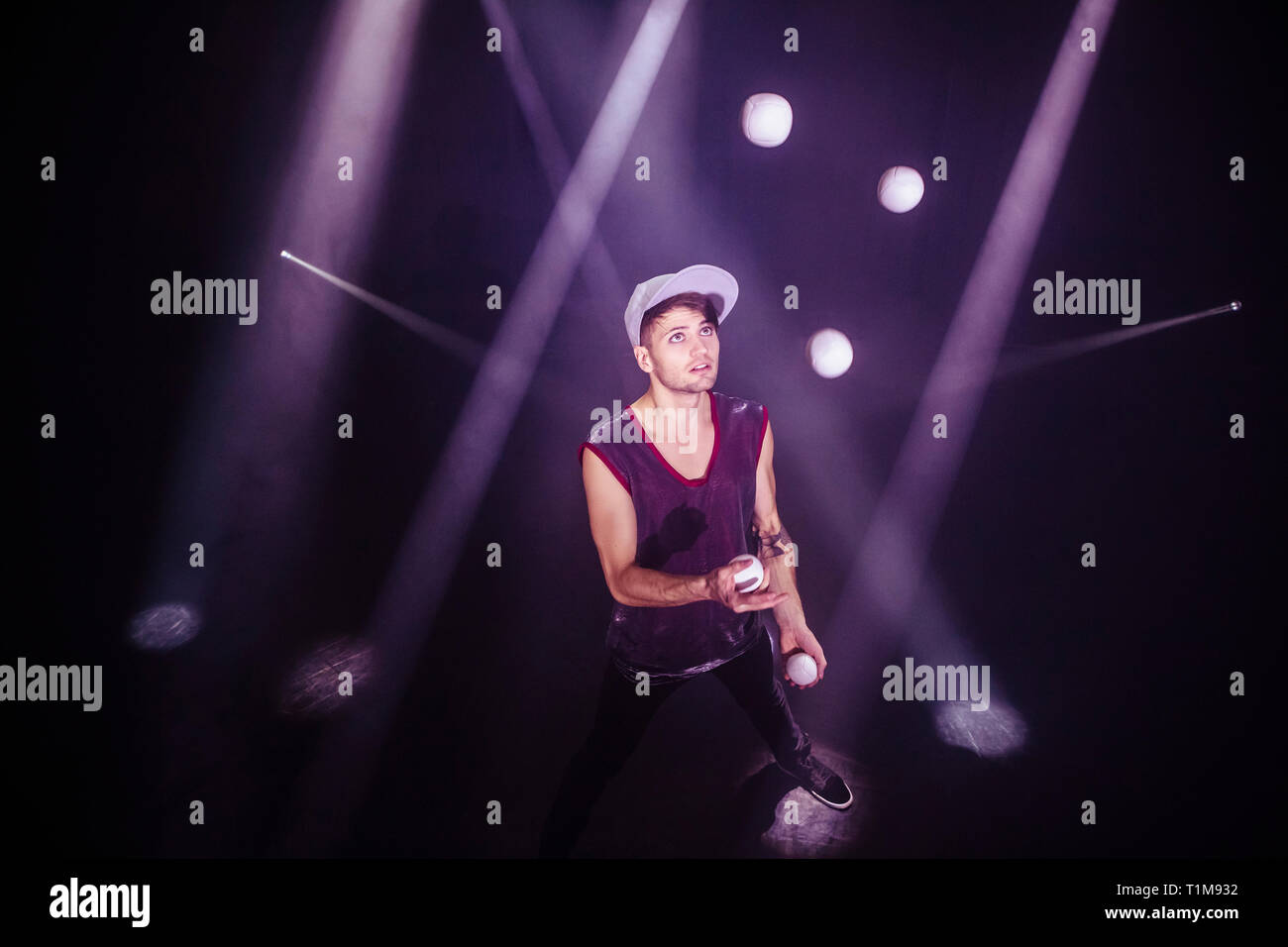 Male performer juggling on stage Stock Photo - Alamy