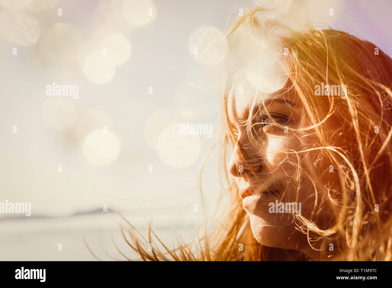 Serene woman enjoying sunshine Stock Photo - Alamy