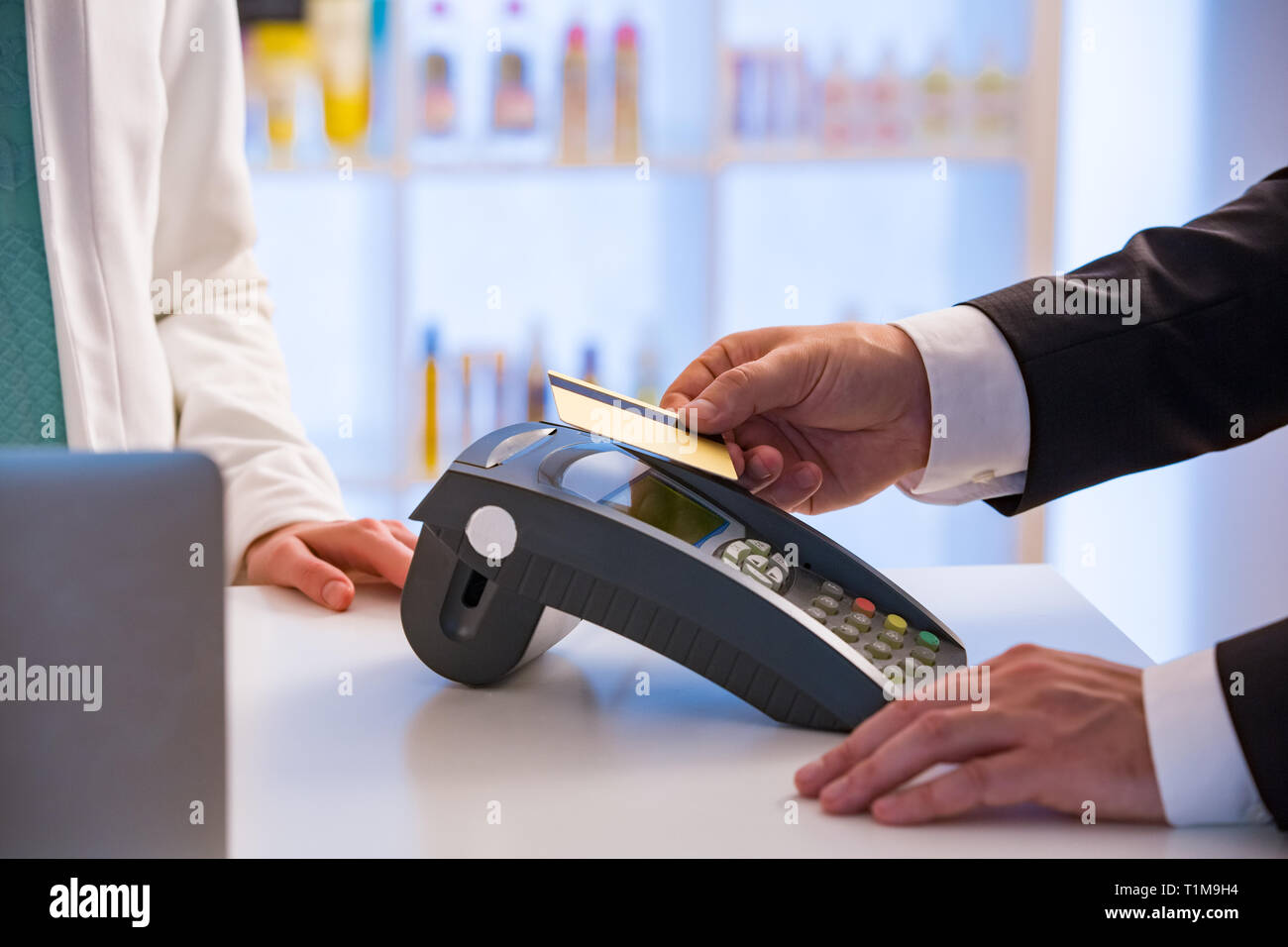 Customer paying with contactless card. NFC technology payment in store ...