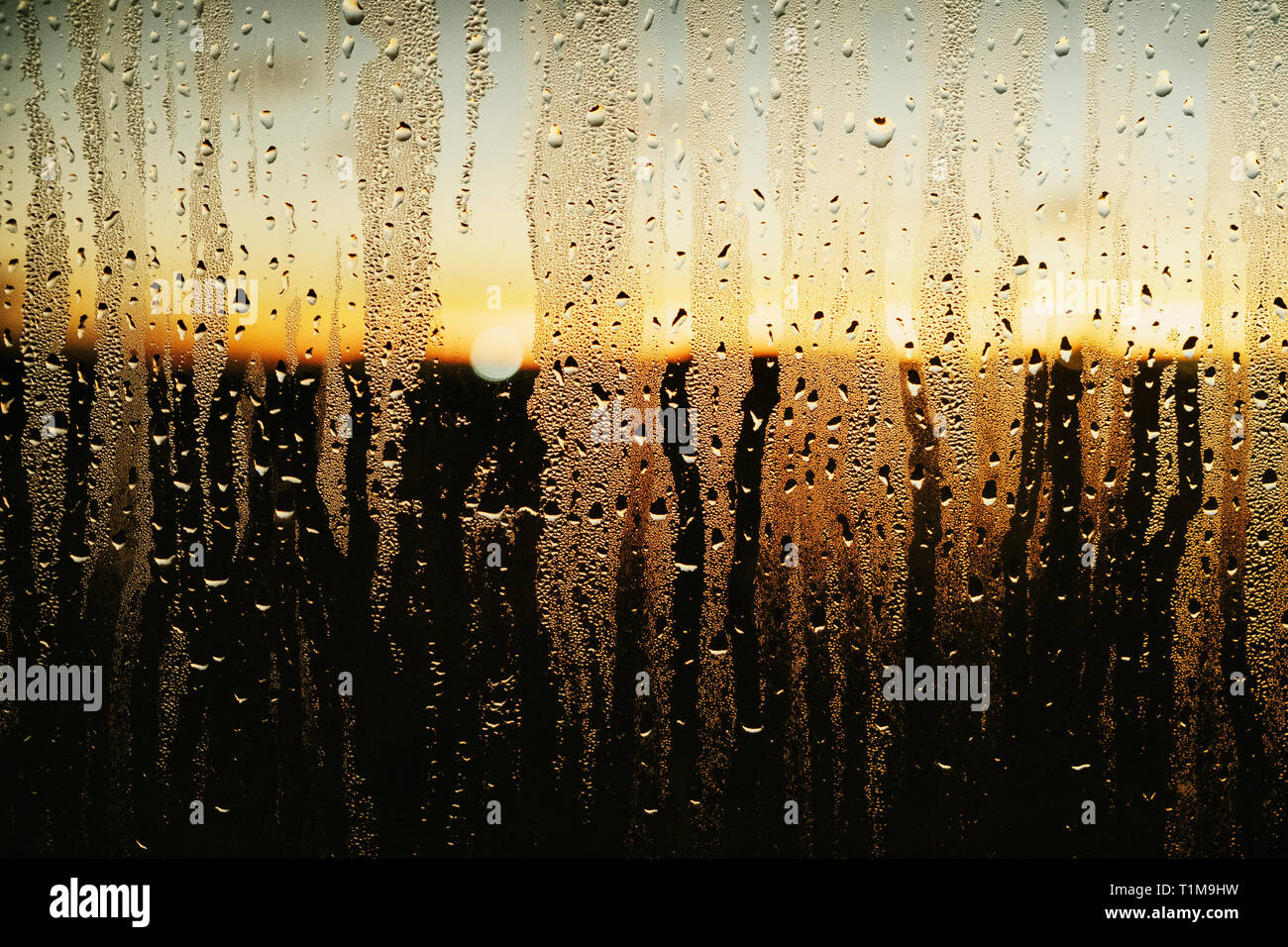 Raindrops and condensation on window with scenic sunset view Stock ...