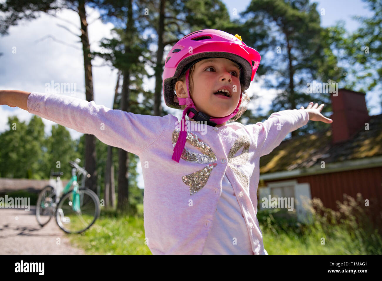 Cute little girl riding bike. Happy active kid. Sunny summer day on ...