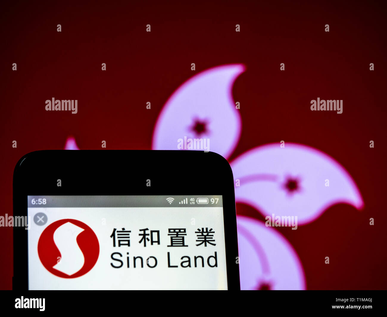 In this photo illustration a Sino Group logo seen displayed on a smart ...