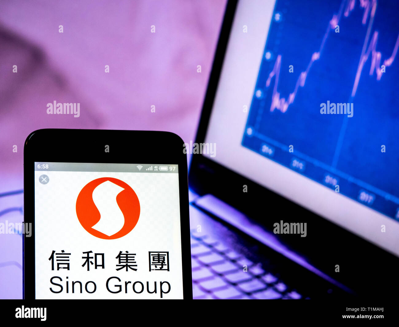 In this photo illustration a Sino Group logo seen displayed on a smart ...