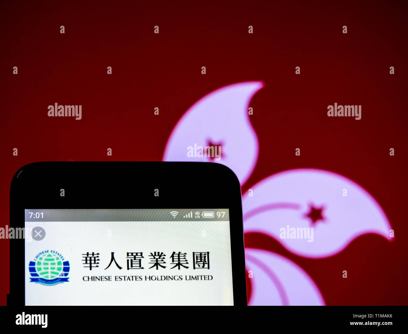 In this photo illustration a Chinese Estates Group logo seen displayed ...