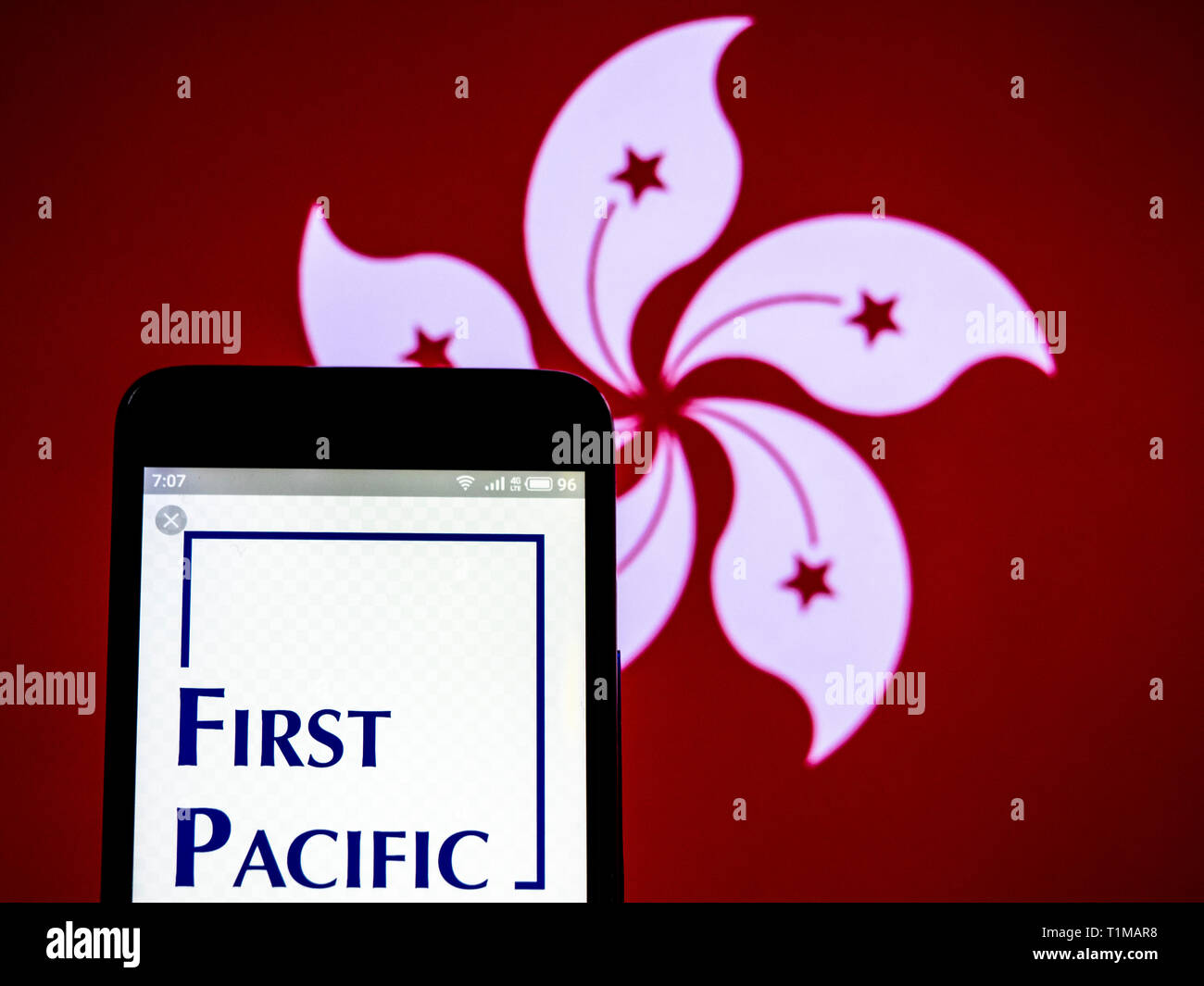 In this photo illustration a First Pacific Company logo seen displayed ...