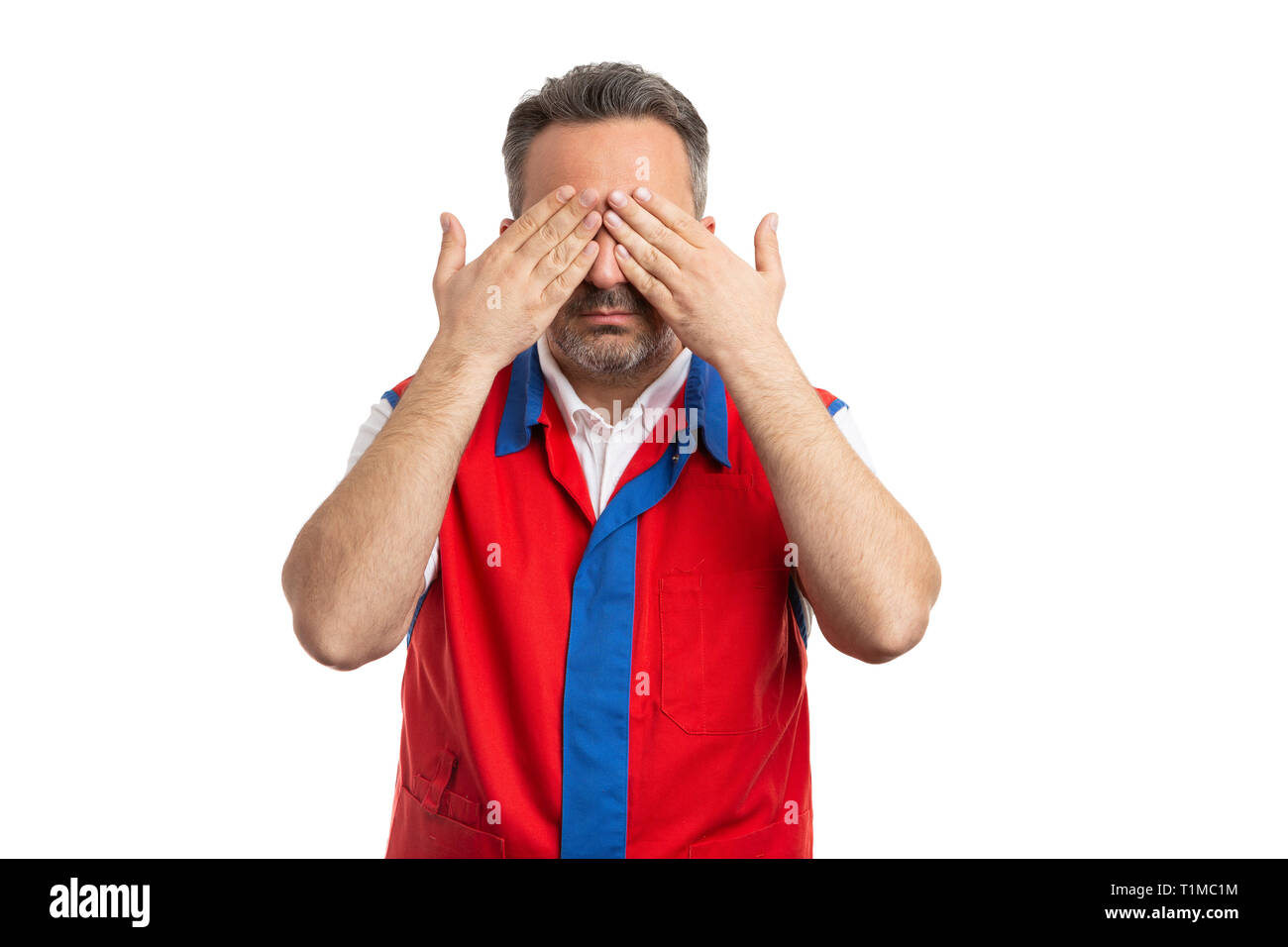 Male hypermarket or supermarket employee covering eyes with hands as ...