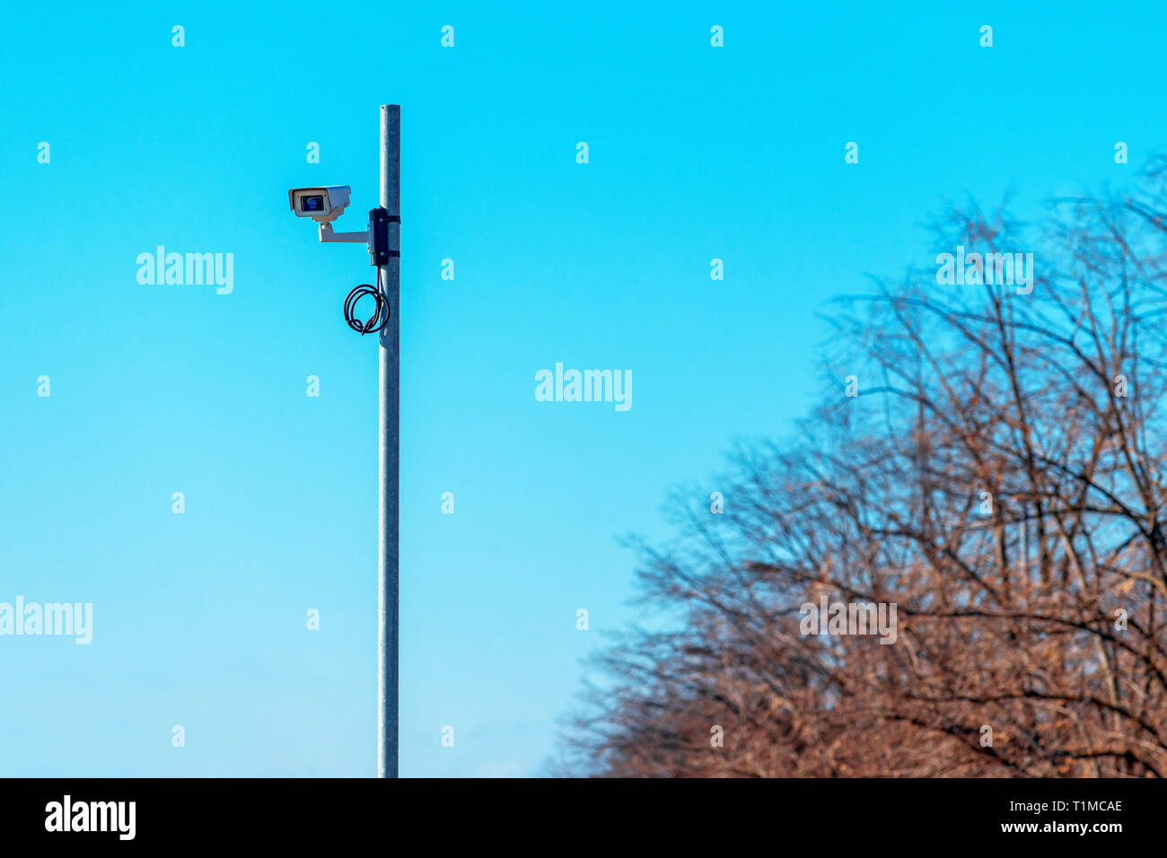 Traffic surveillance camera mounted on the post with large portion of ...