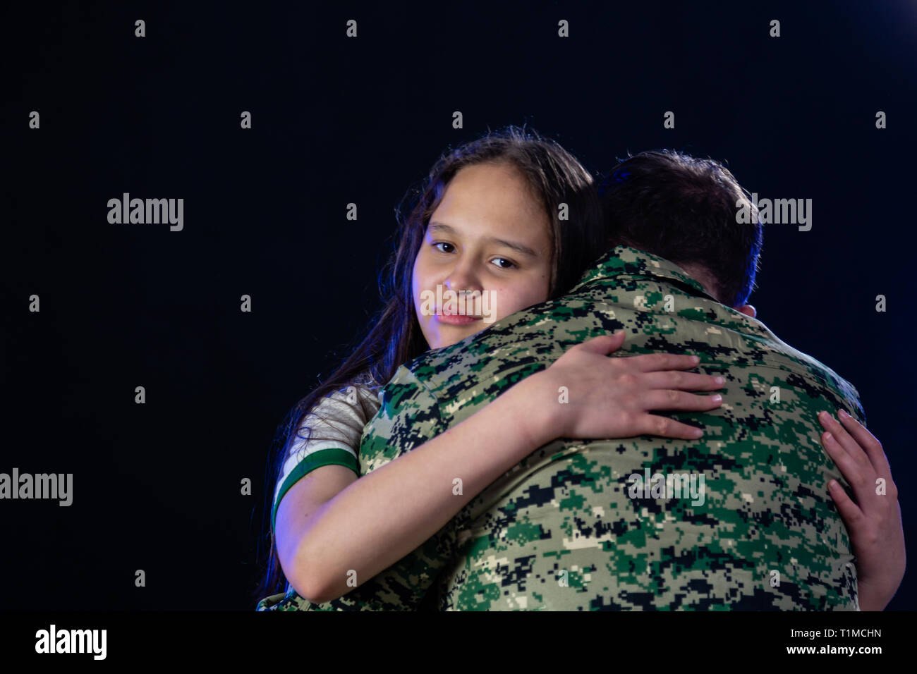 Soldier hugs daughter on departing or returning from war Stock Photo ...