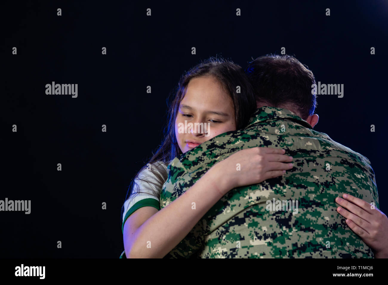 Soldier with gun hugging child hi-res stock photography and images - Alamy