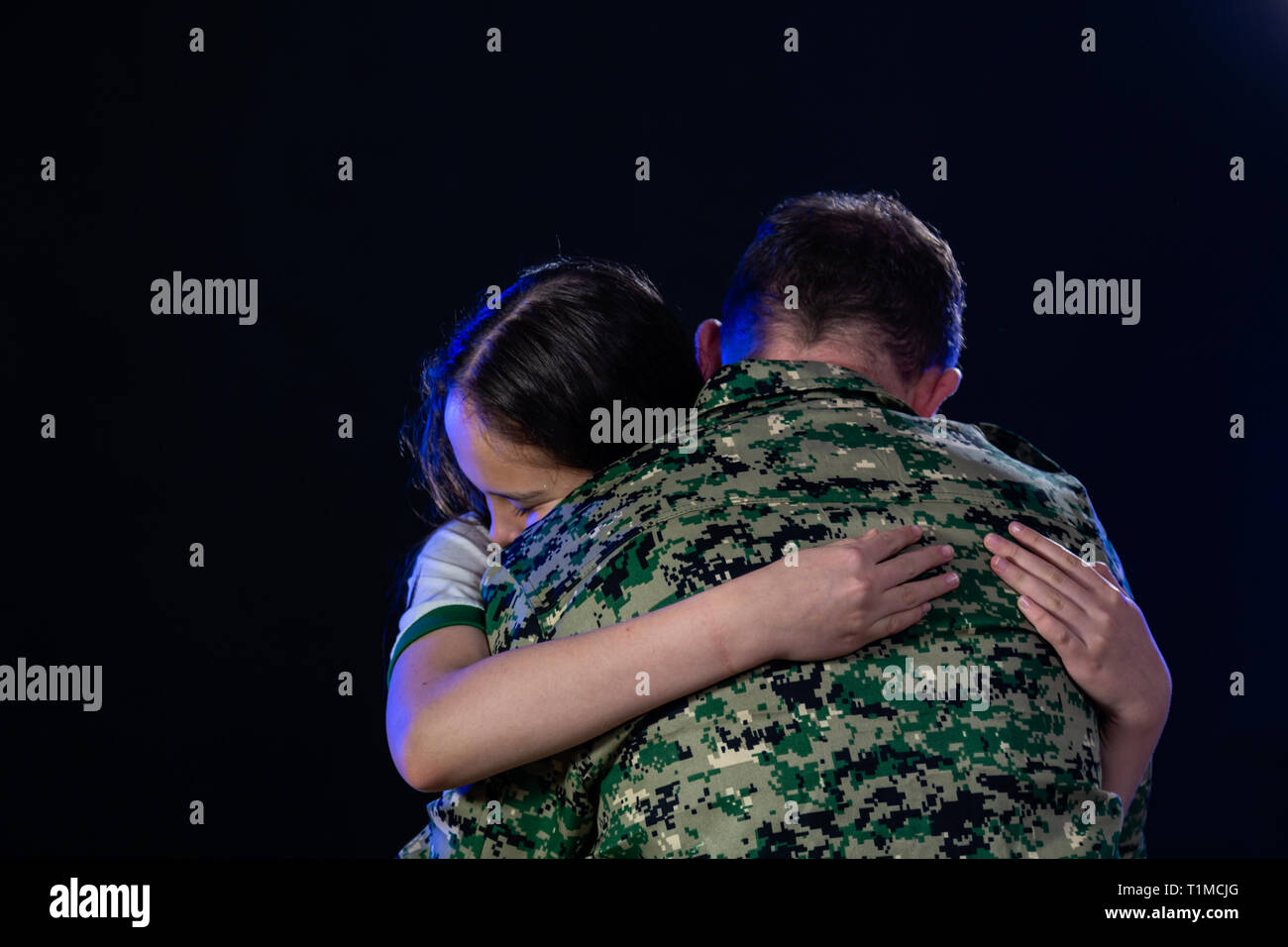 Soldier hugs daughter on departing or returning from war Stock Photo ...