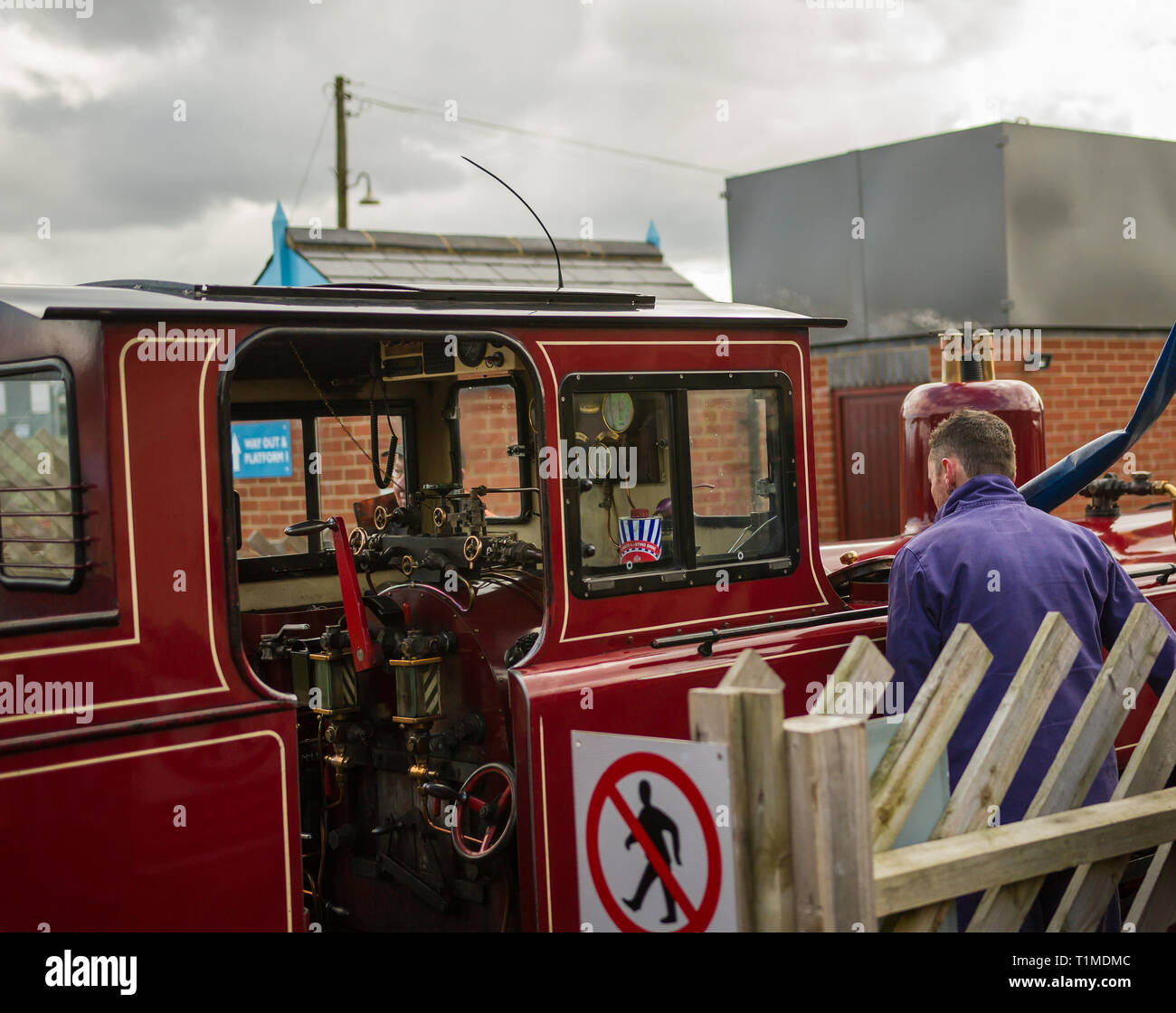 Train and railway engineer working on a steam train on the Bure Valley ...