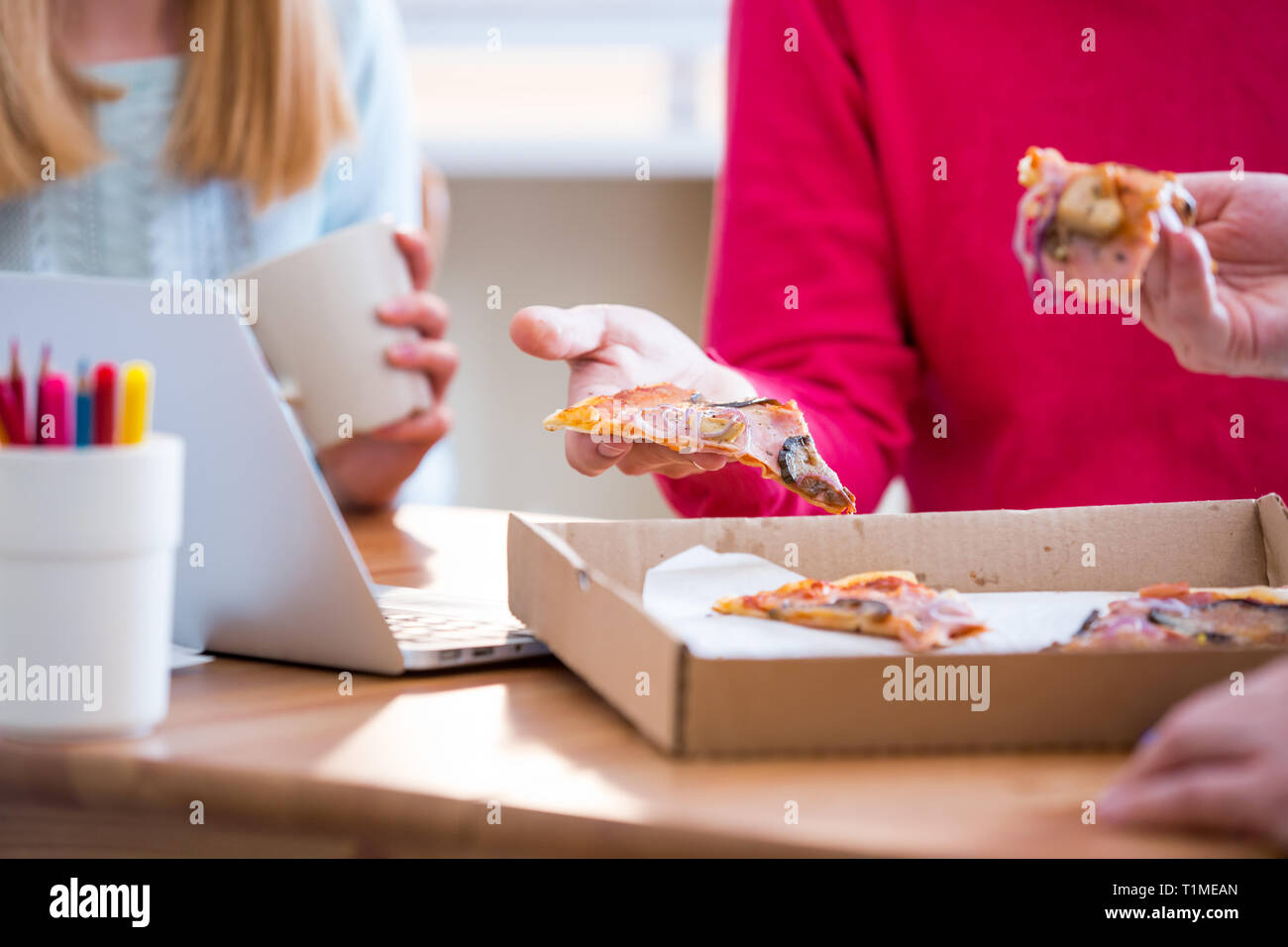 Happy business People Having Meeting And Eating Pizza in office. Three ...