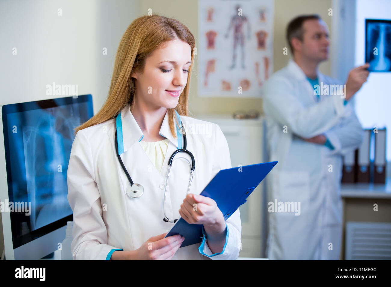 Portrait of friendly confident doctors in hospital. Enthusiastic ...
