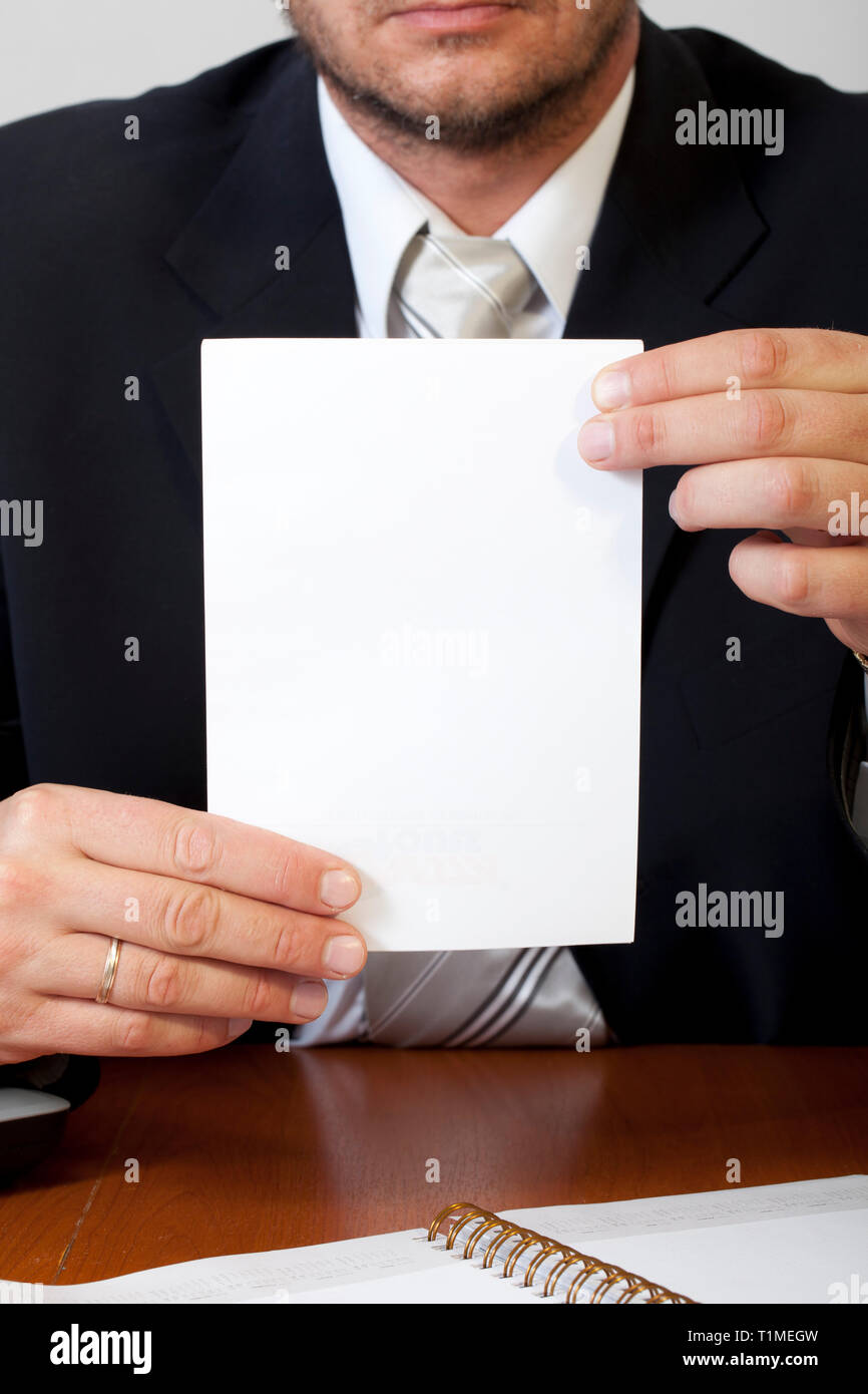 Man holds white card in hand Stock Photo - Alamy