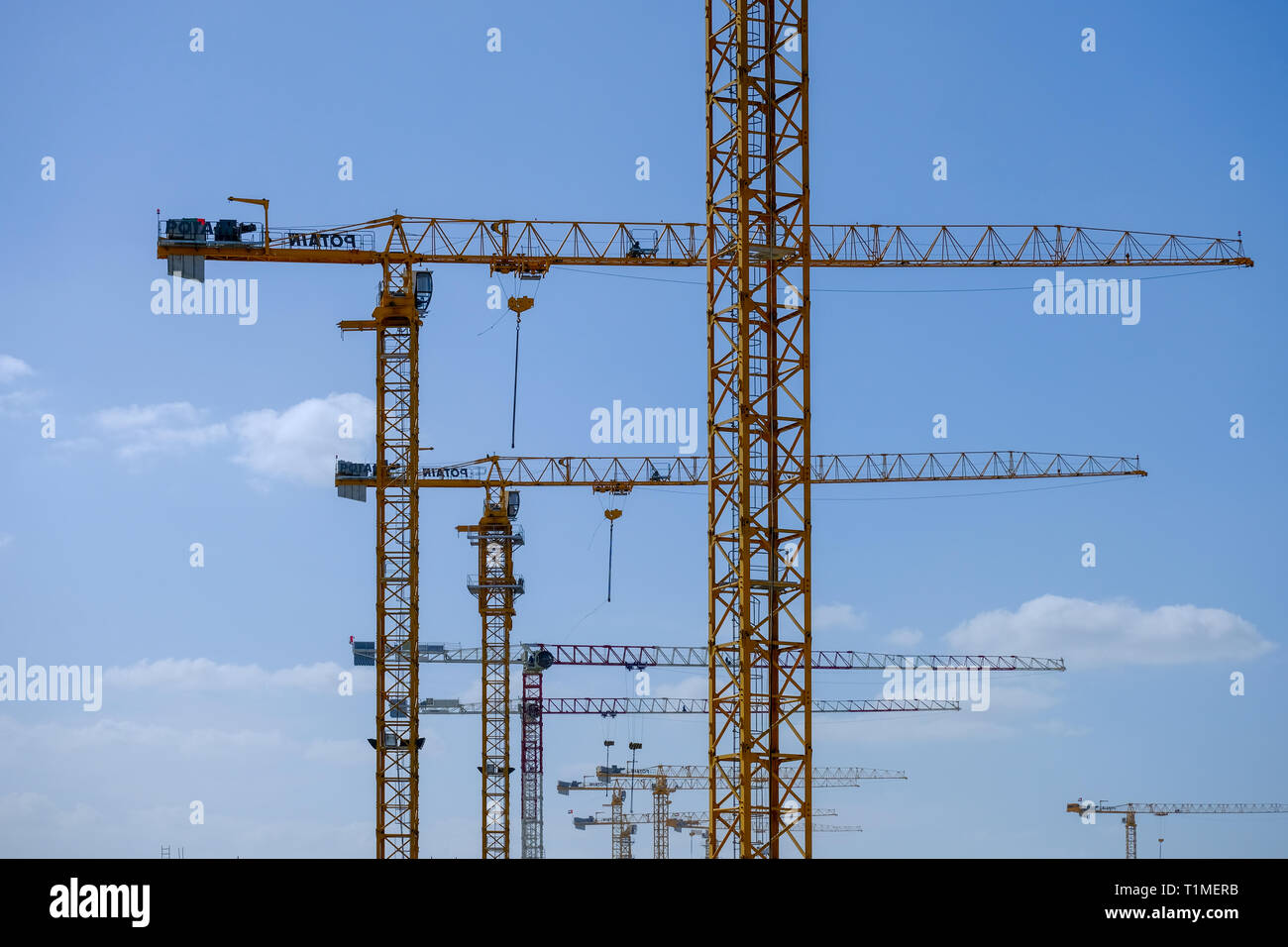 Row of tower crane at construction site Stock Photo - Alamy