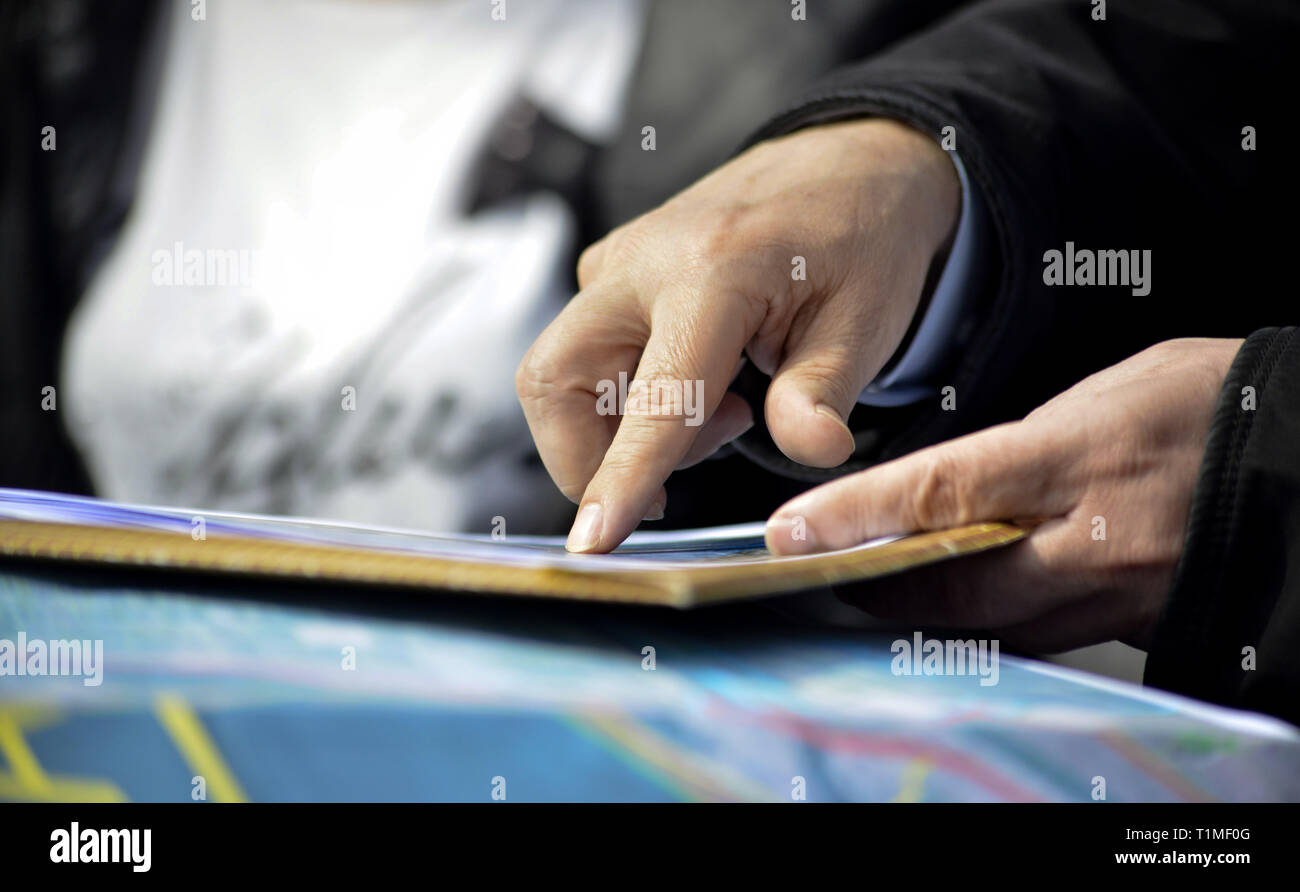 engineer shows on a map outdoor on costruction site Stock Photo - Alamy