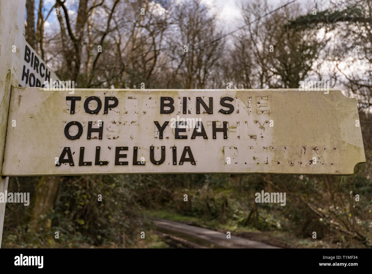 Rural sign post with letters reorganised Stock Photo - Alamy