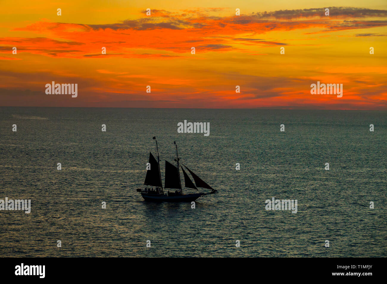 Tall ship tourist sail boat at sunset at Key West, a U.S. island city ...