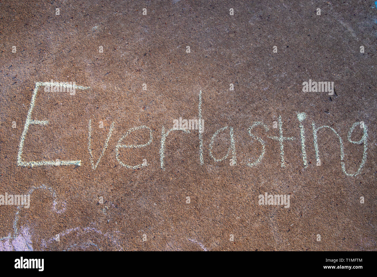 the word Everlasting written with sidewalk chalk on gray concrete ...