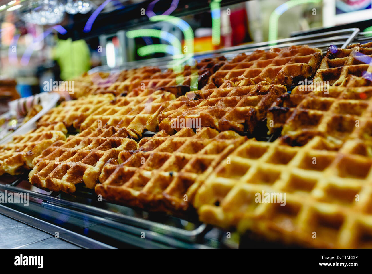 Group of freshly baked waffles ready to be savored for sale at a fair ...