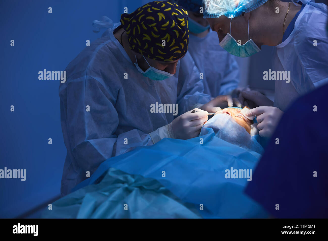 Surgical team performing surgery in modern operation theater,Team of ...