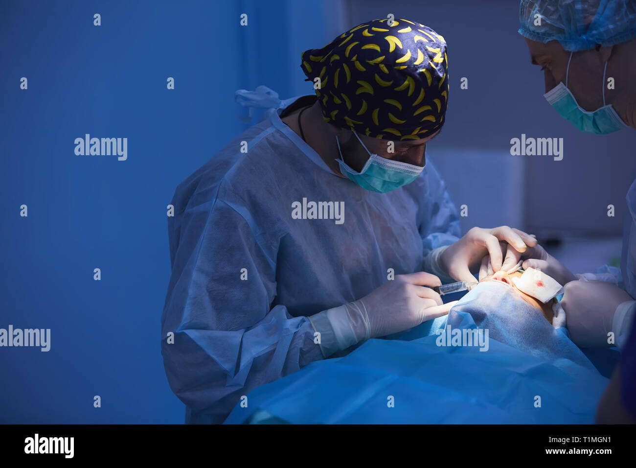 Surgical team performing surgery in modern operation theater,Team of ...