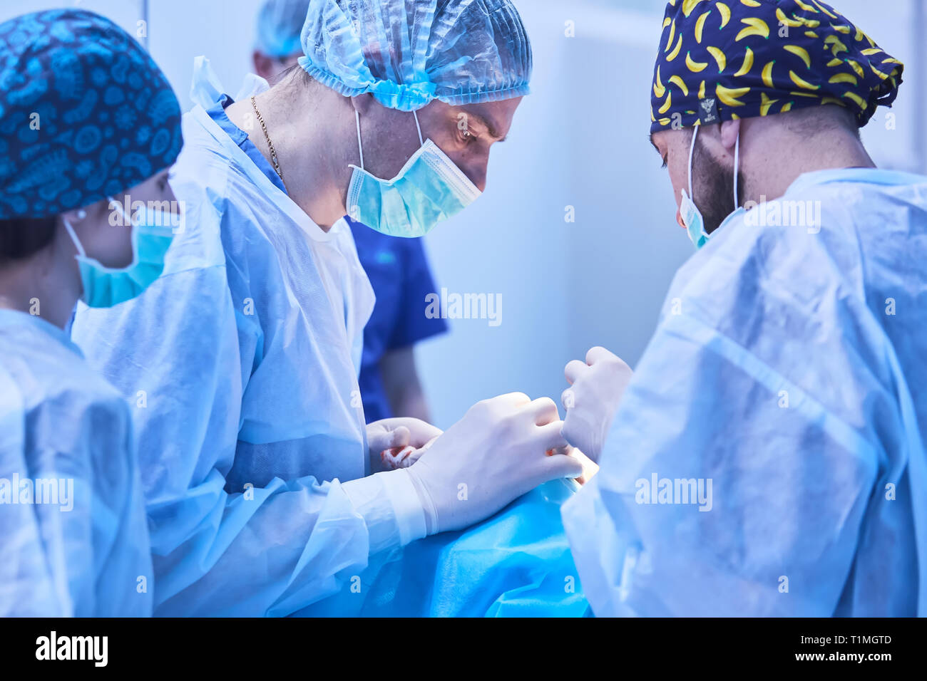 Serious surgeons during a surgery in the hospital. Cross Process Stock ...