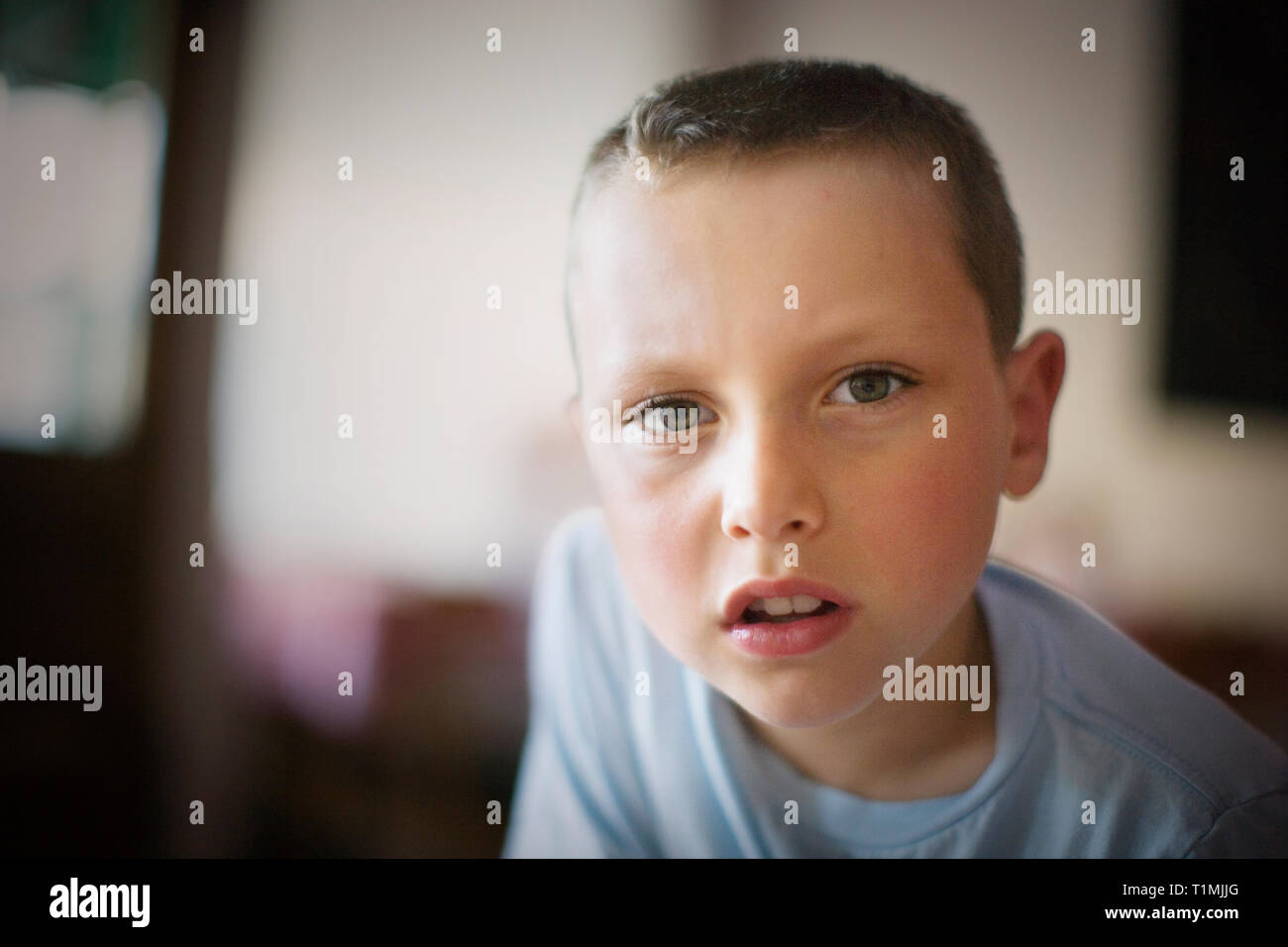 Portrait of a boy sitting in a house Stock Photo - Alamy