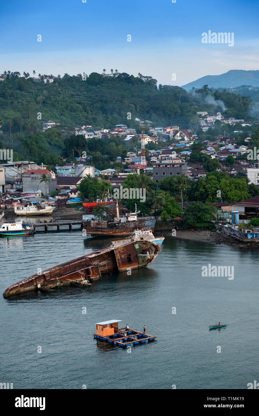 View of the skyline of Ambon city and shipwrecks in the harbor area ...
