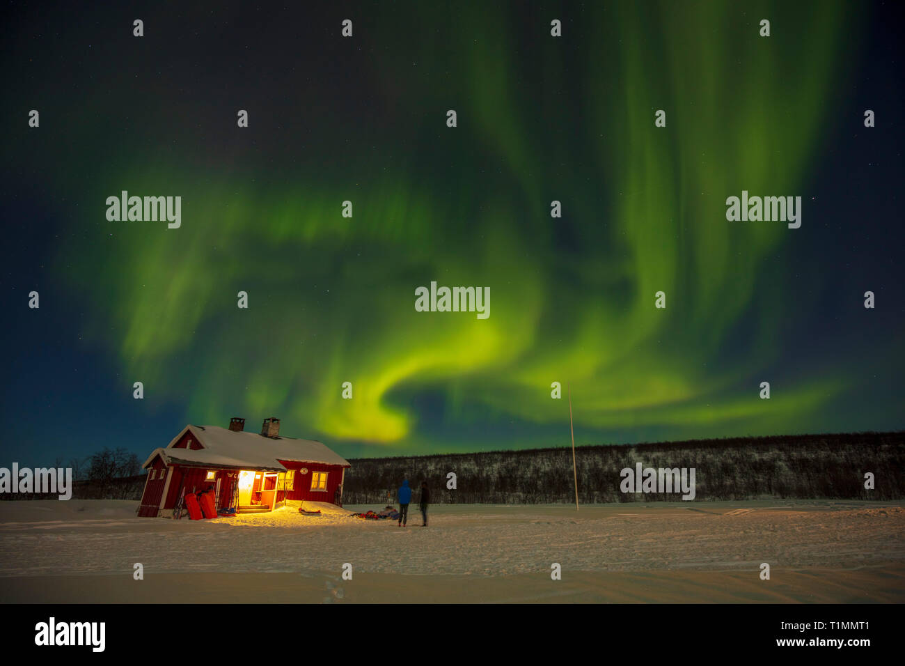 Aurora borealis over Ravnastua mountain lodge, on the Finnmarksvidda ...