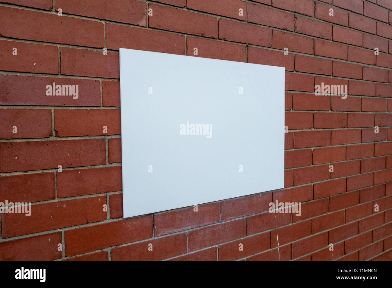 Abstract photograph of a Blank white rectangular sign panel fastened to ...